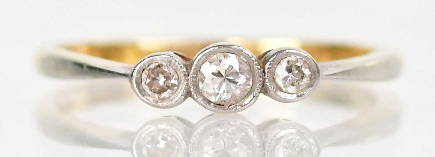 An 18ct yellow gold and platinum ring set with three diamonds in collet ...