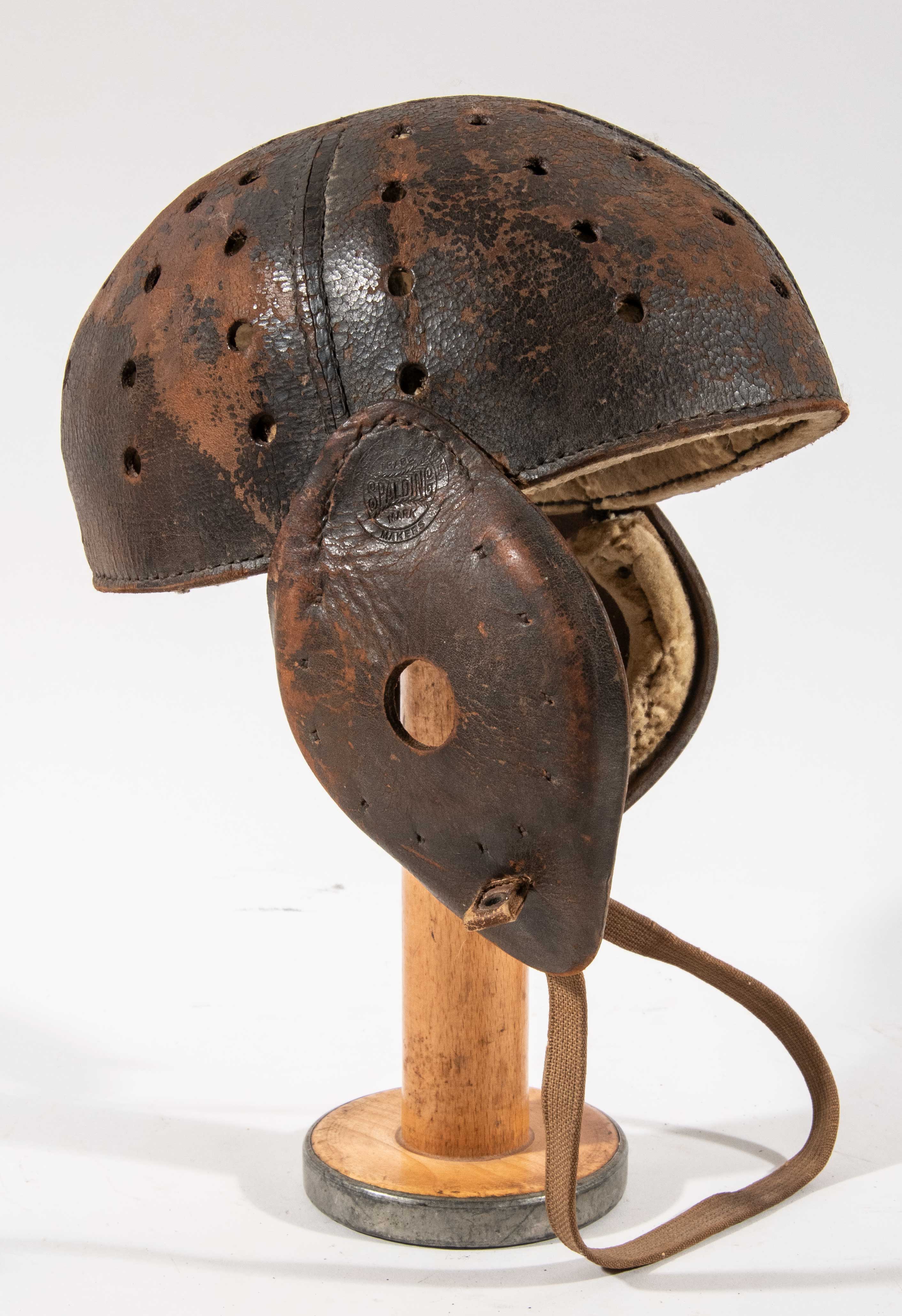 Spalding brand raincap style football helmet c.1910s-20 | Barnebys