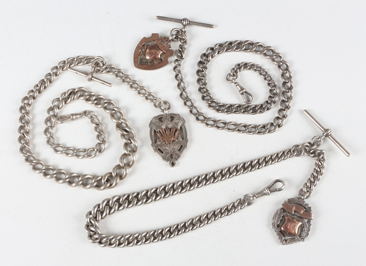 A group of three silver graduated curblink Albert watch chains, each ...