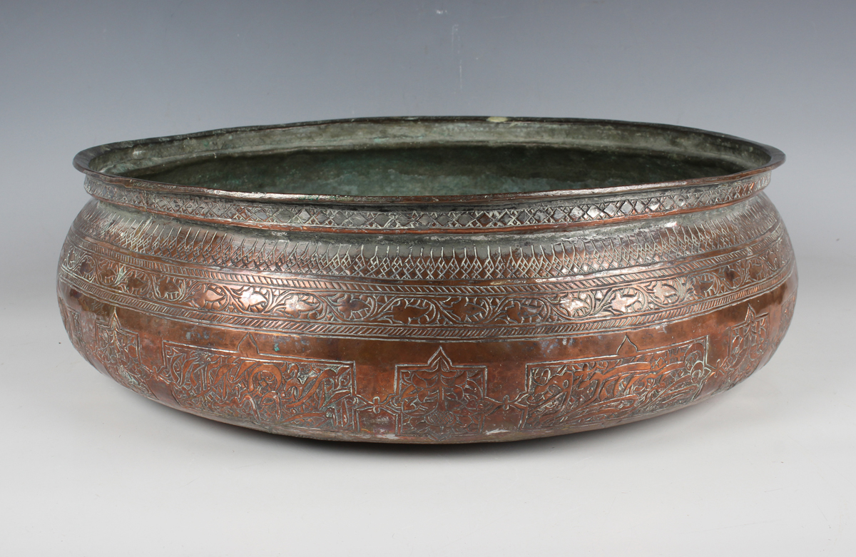 A Persian copper bowl, 19th century, of shallow circular form, the ...