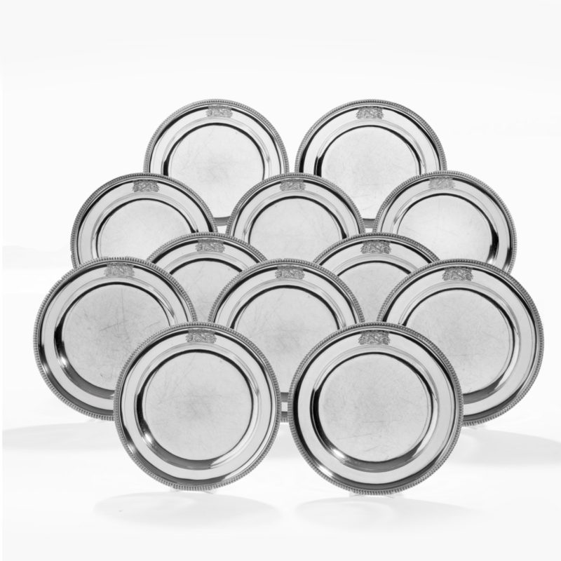 A set of 24 George III silver dinner plates by Henry Nutting 1810 ...