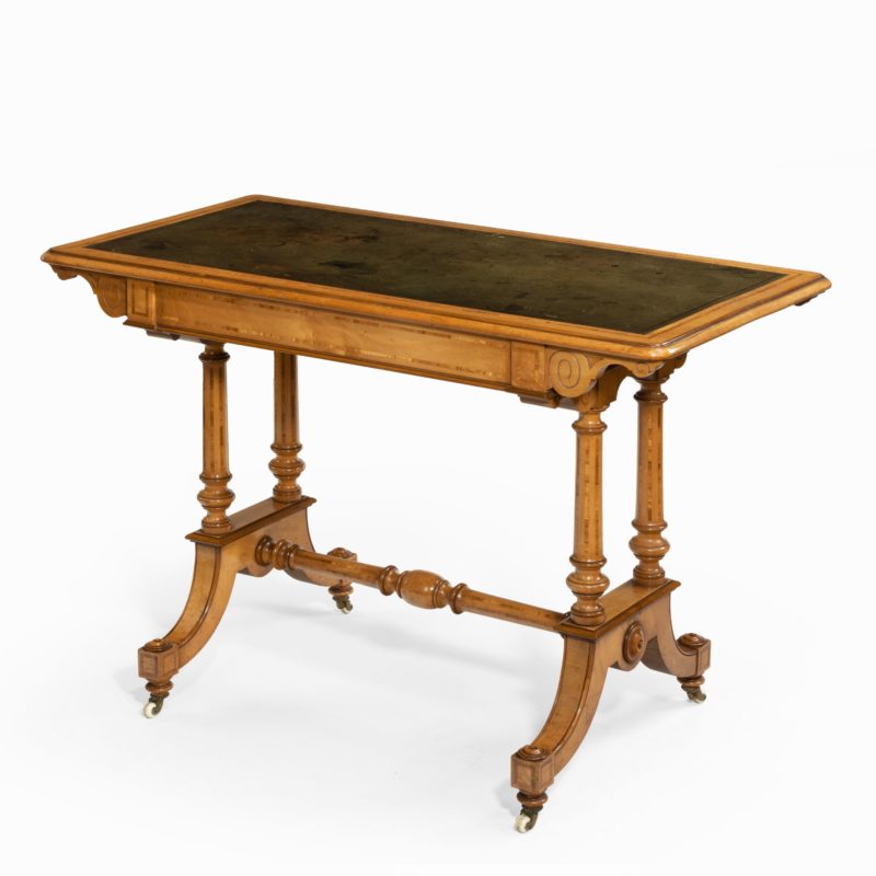 A Victorian birch or satinwood writing table, attributed to Holland and ...
