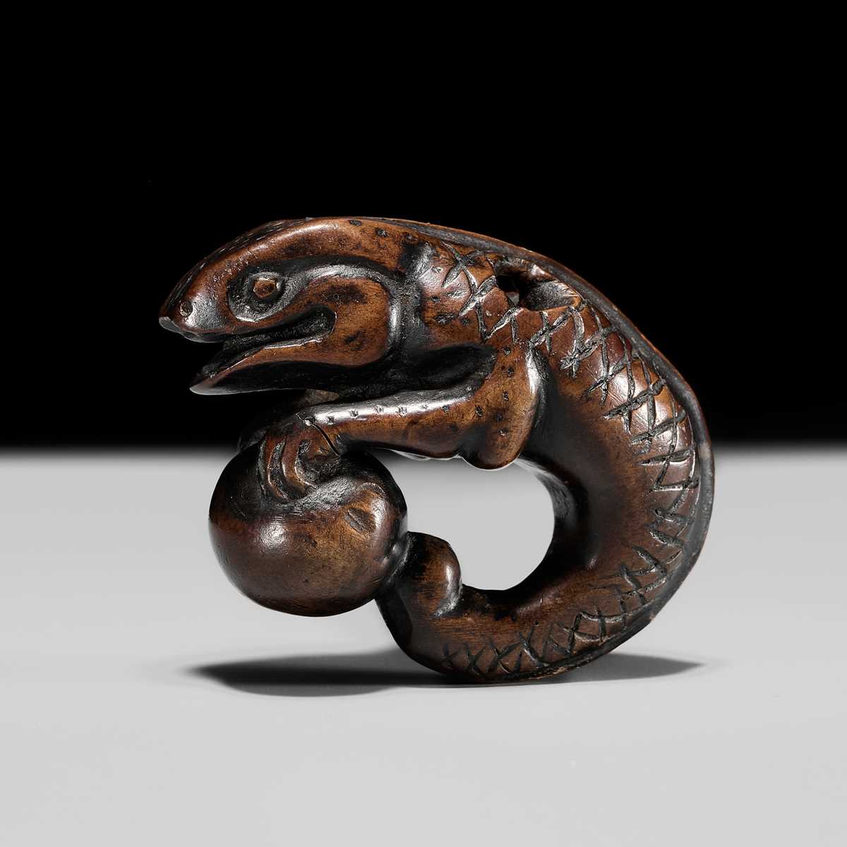 A LARGE AND UNUSUAL WOOD NETSUKE OF A MYTHICAL BEAST | Barnebys