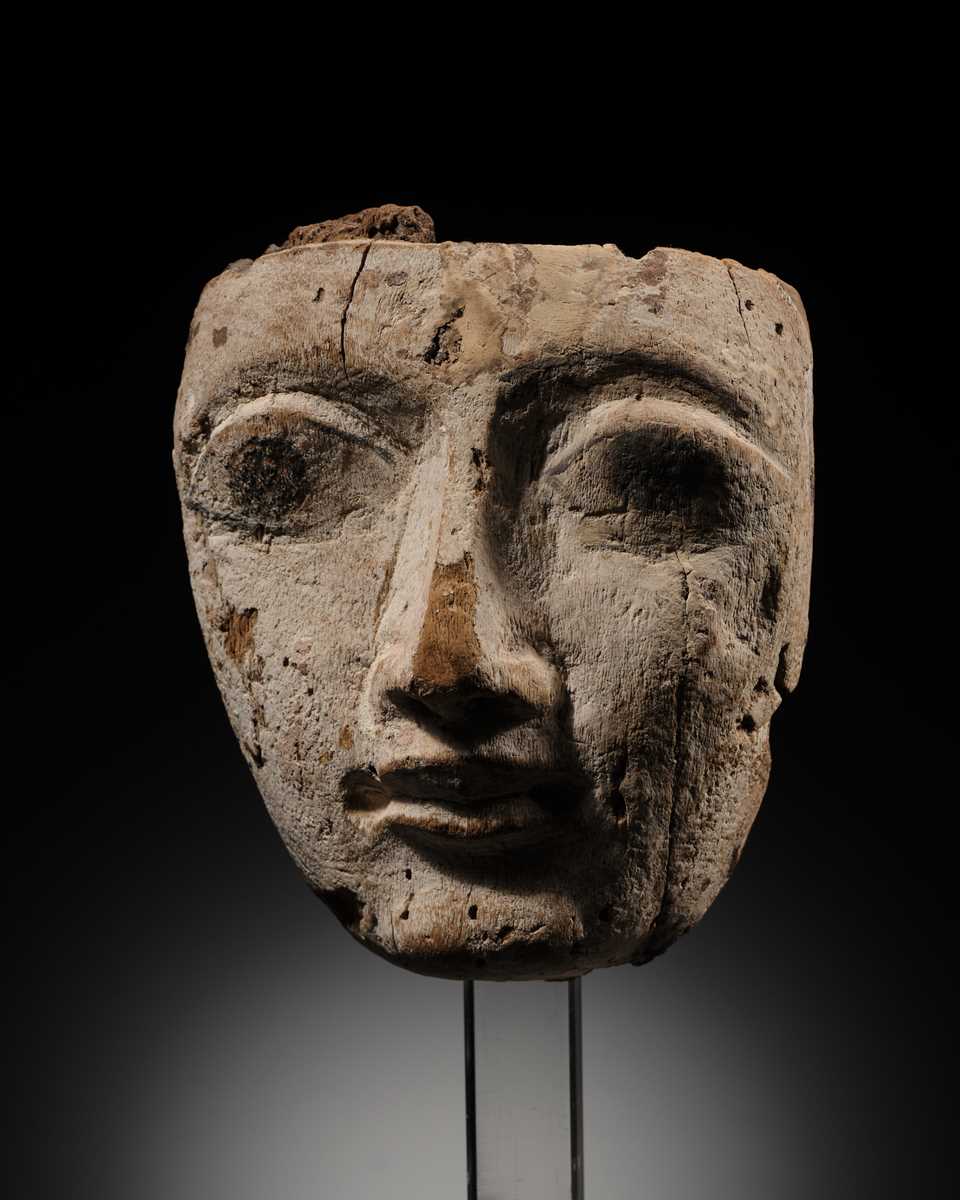AN EGYPTIAN GESSO PAINTED WOOD SARCOPHAGUS MASK, LATE PERIOD, 664-332 ...
