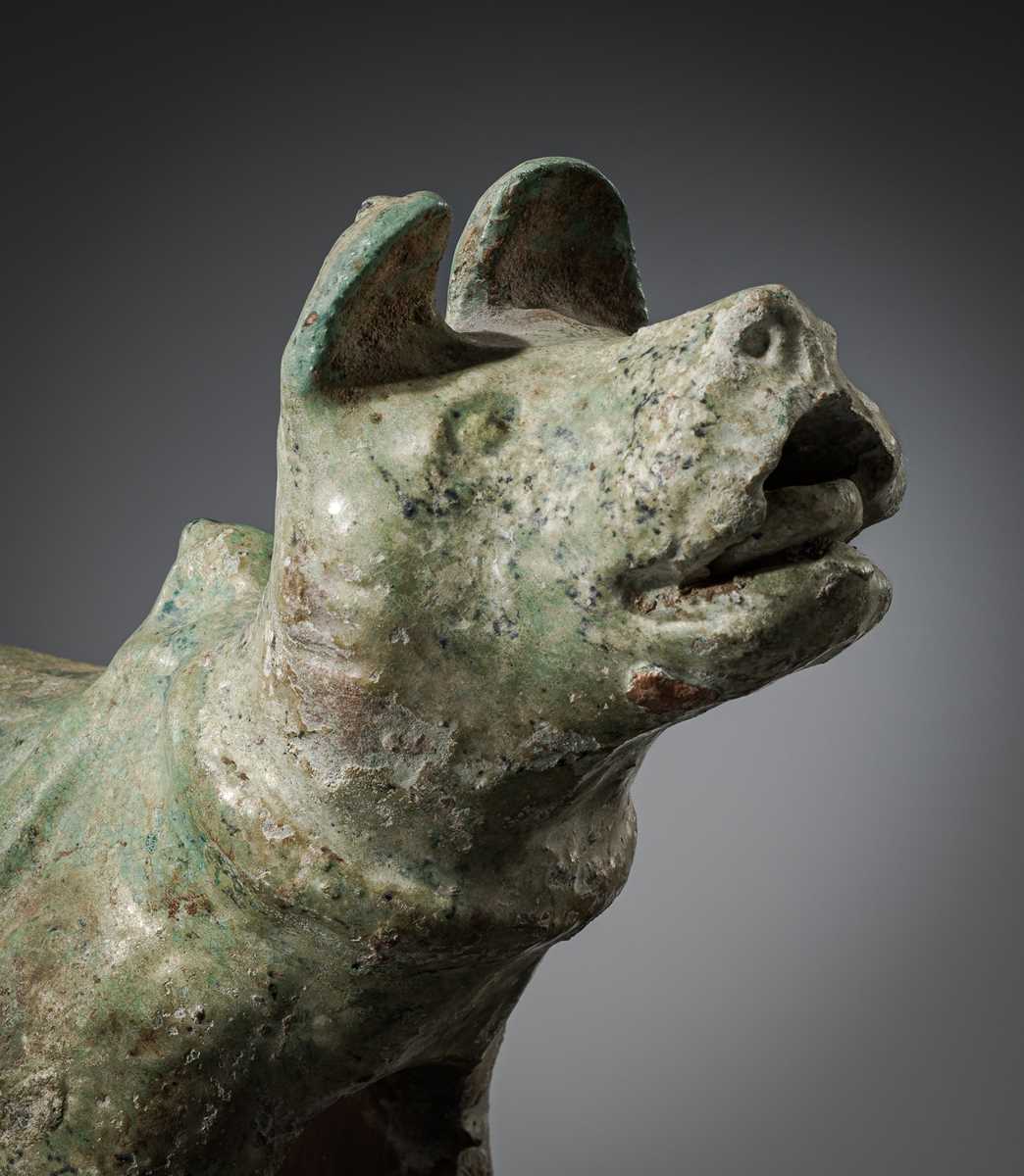 A GREEN-GLAZED POTTERY FIGURE OF A DOG, HAN DYNASTY | Barnebys