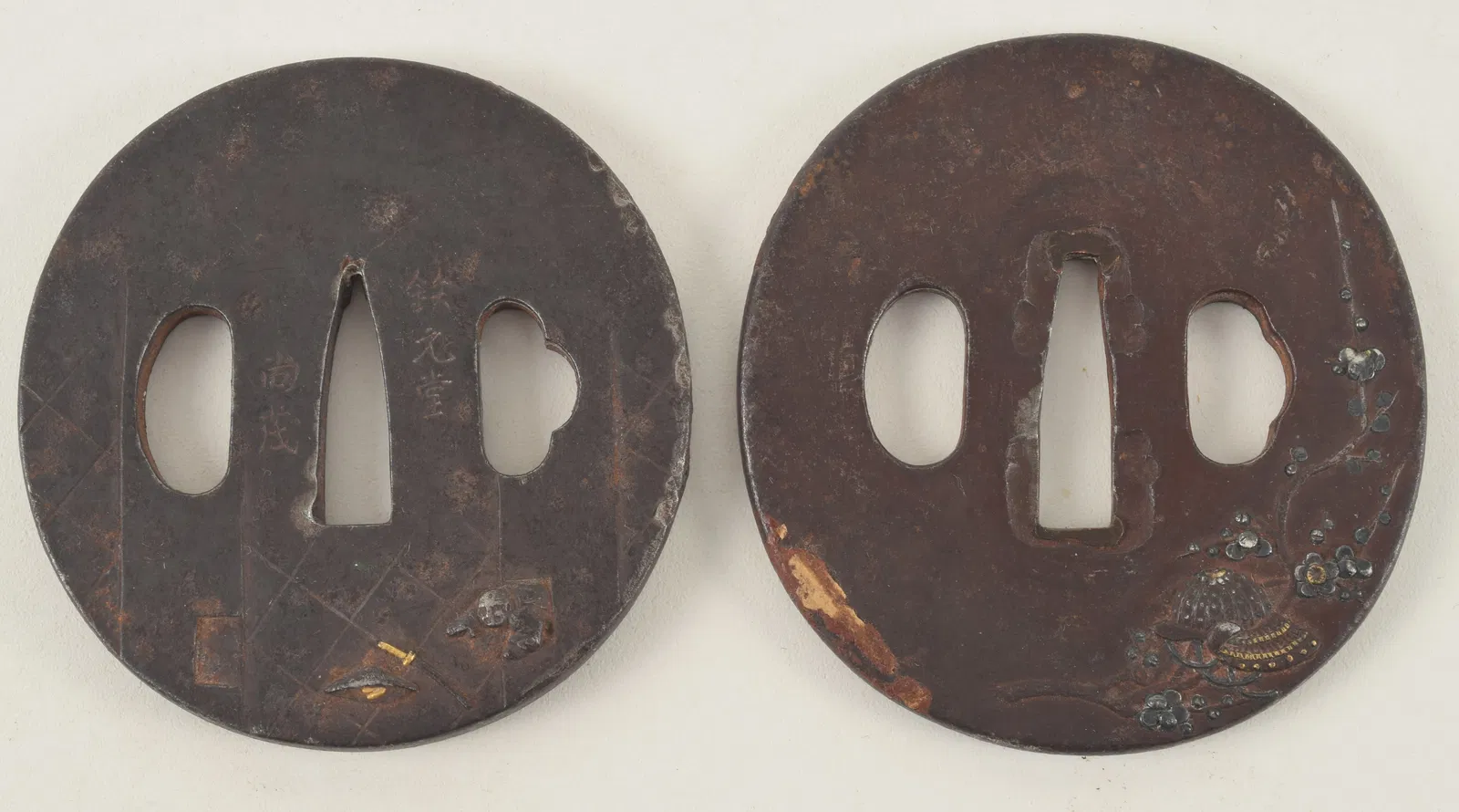 2 sword guards. Japan. 19th century. Iron tsuba with gold and silver ...