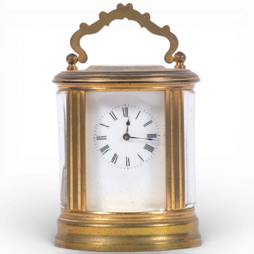 A modern miniature oval brass-cased carriage clock, 8-day mo... | Barnebys
