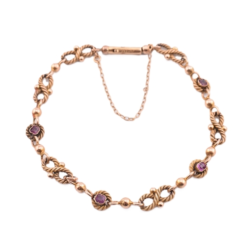 A 19th-century gold and ruby lover's knot bracelet. The anti... | Barnebys
