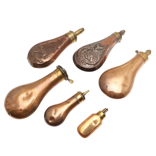 A COLLECTION OF BRASS AND COPPER POWDER FLASKS. A copper bod... | Barnebys