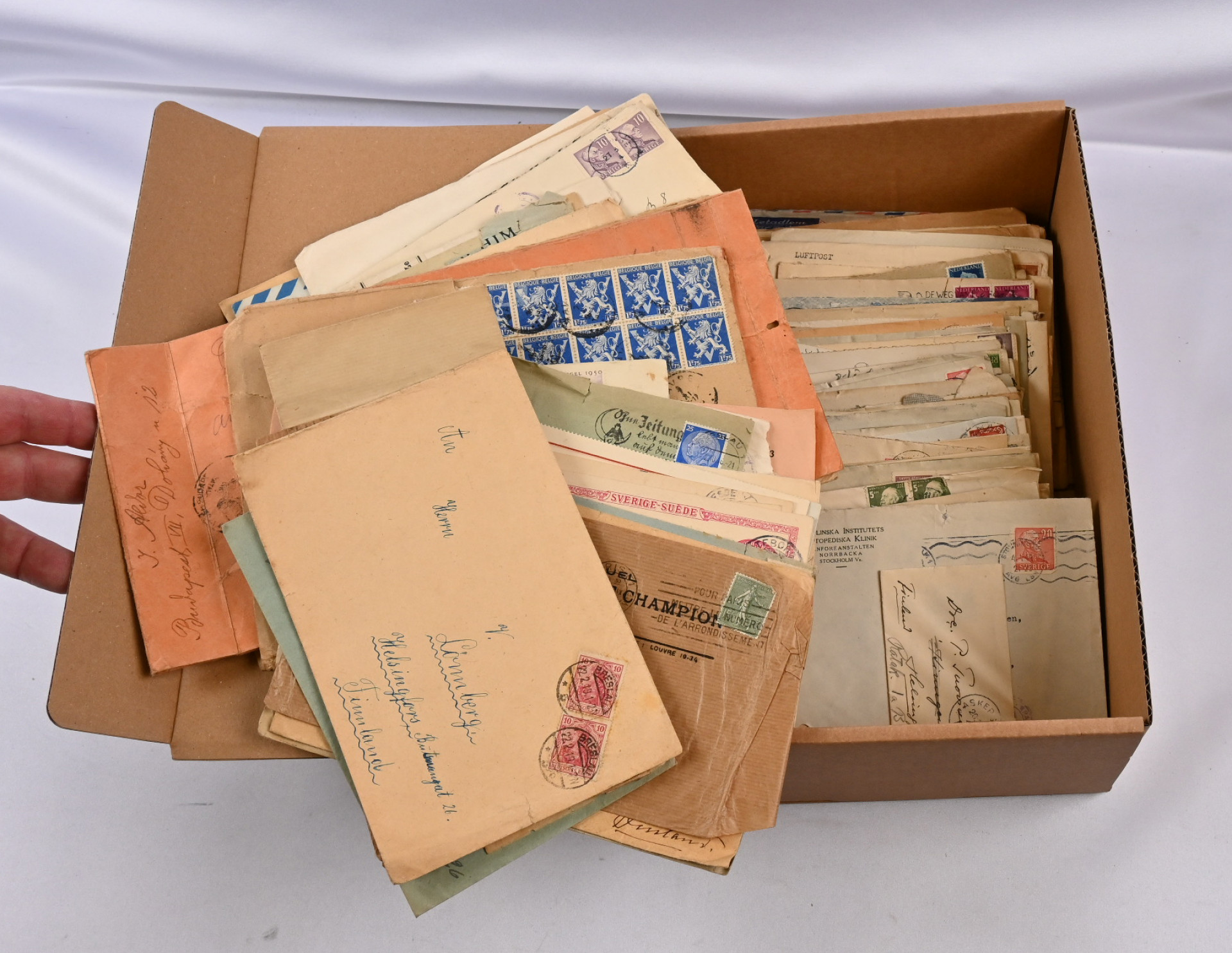 Old foreign postal items in a box, ca. 1.3 KG. From early 20th century ...