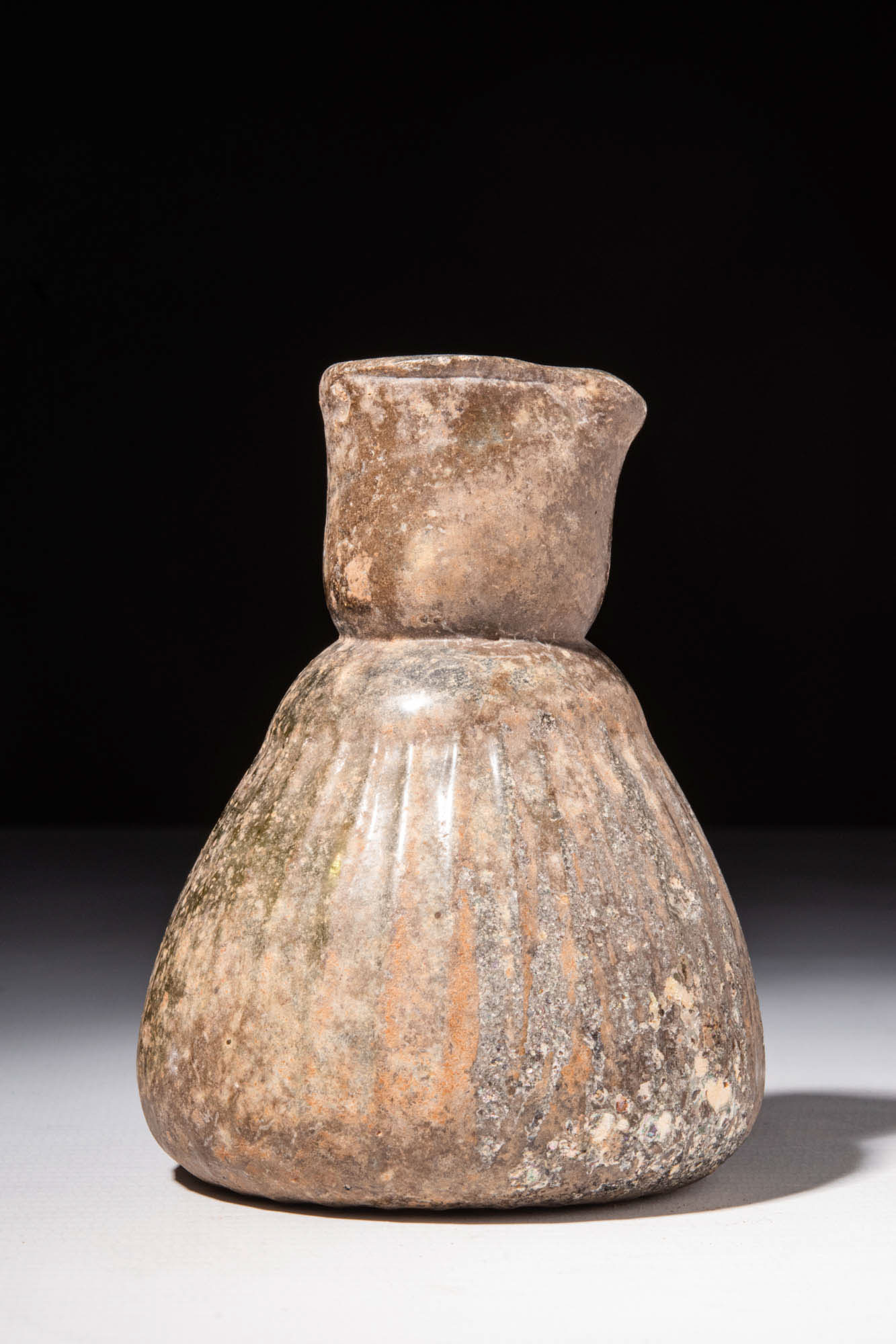 ABBASID PEAR-SHAPED RIBBED GLASS FLASK | Barnebys