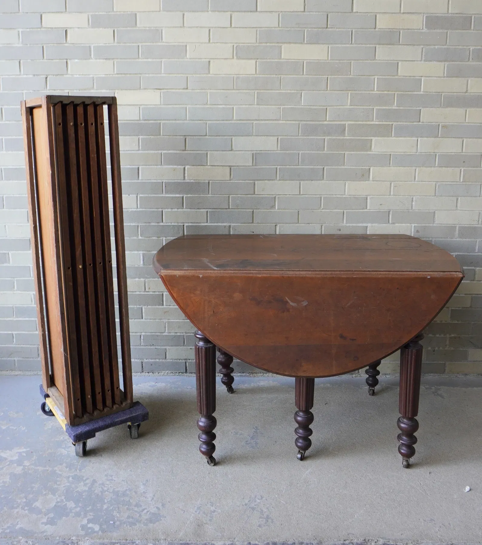 A black walnut drop-leaf banquet table with 5 leaves and center support ...